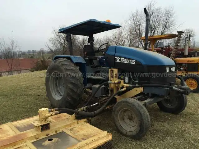 1999 New Holland Farm Tractor with side brush cutter | GovDeals